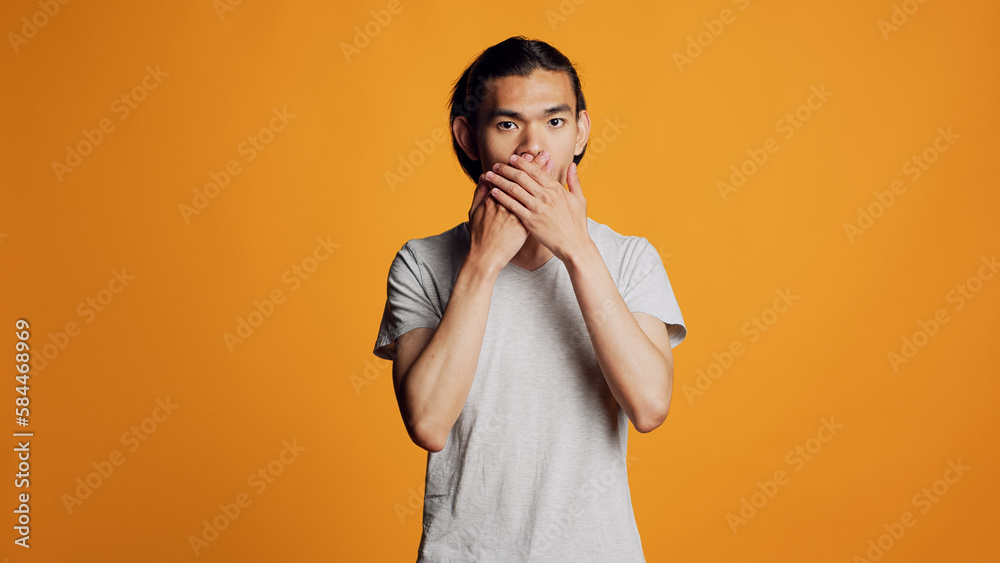 Confident hipster guy doing three wise monkeys sign on camera, using ...
