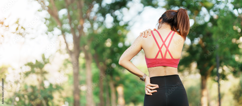 Young fitness woman holding her sports injury shoulder and neck, muscle ...