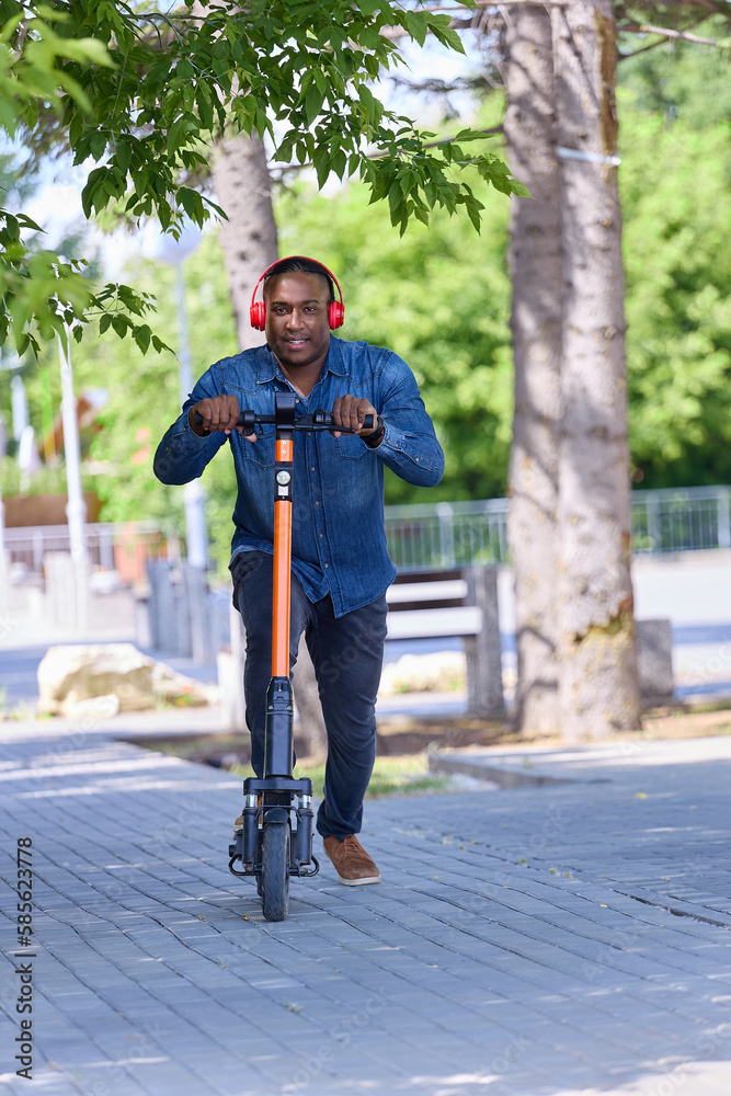 Modern African American student goes to university classes on a scooter ...