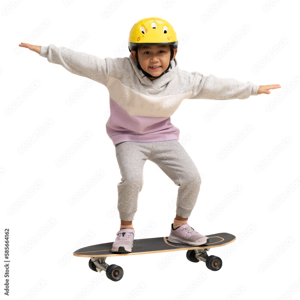 Happy asian smiling little girl playing skateboard wearing a helmet ...