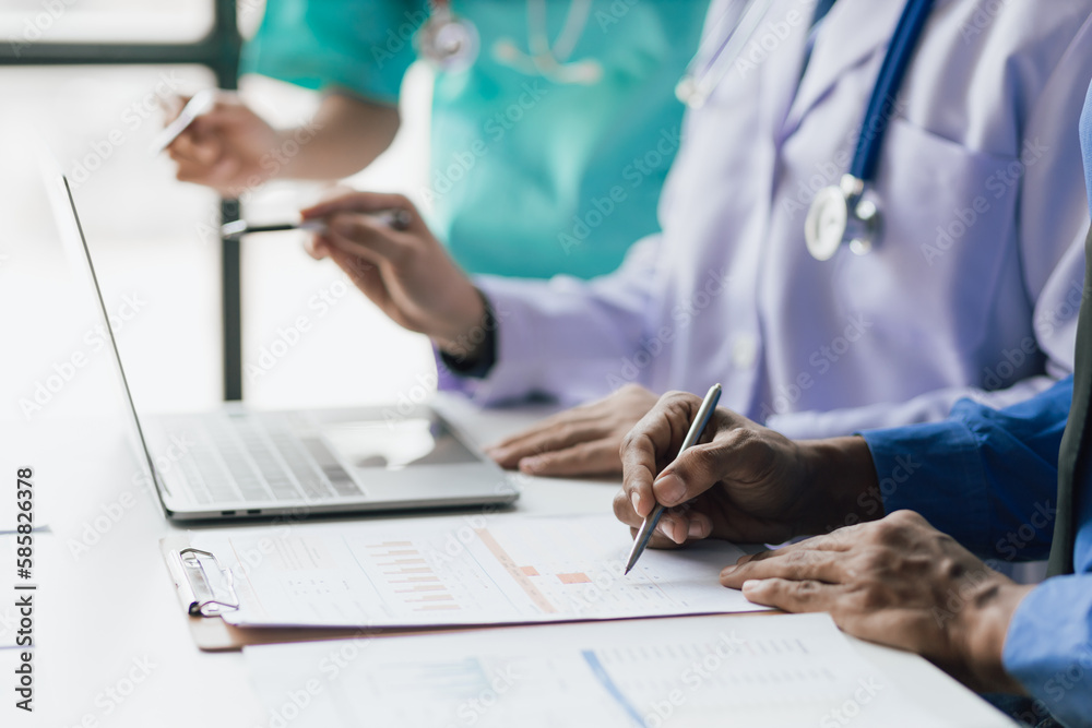 Team, medical analysts and doctors consulting with paperwork of graphs ...