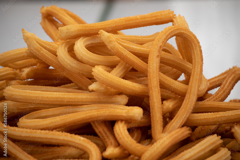 Stack of churros. Typical breakfast of Spanish gastronomy, popular in ...