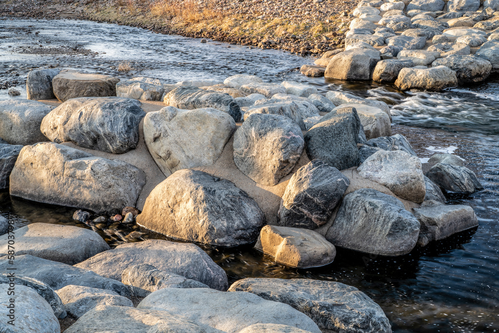wave shaping rock structure exposed at low water in a whitewater park ...
