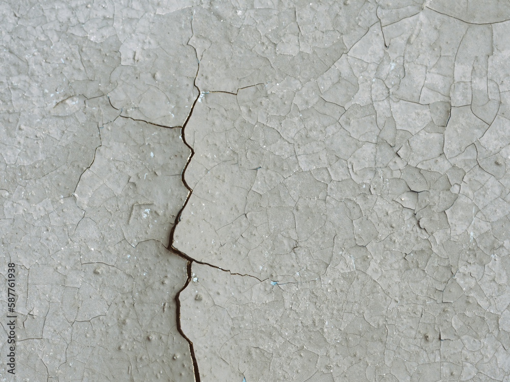 Peeling paint on the wall. Old concrete wall with cracked flaking paint. Weathered rough painted ...