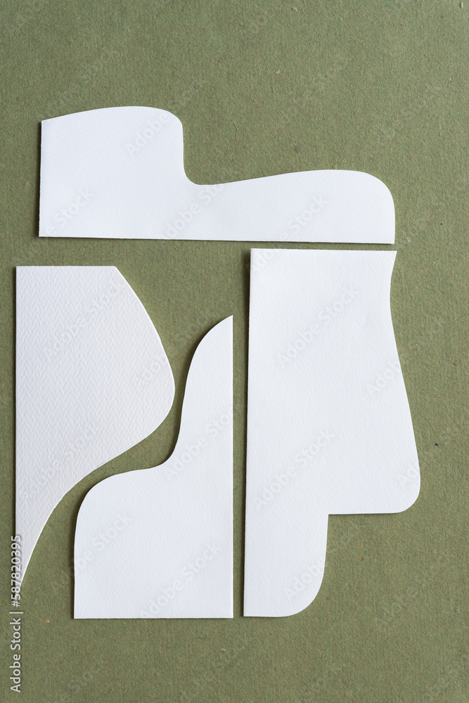 cut white paper shapes with distinct wavy and straight edge forms on ...