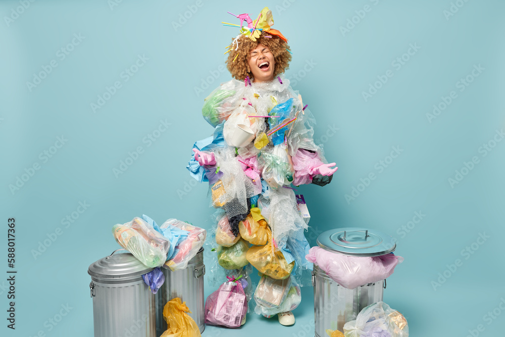 Emotional curly haired active female volunteer covered with plastic ...
