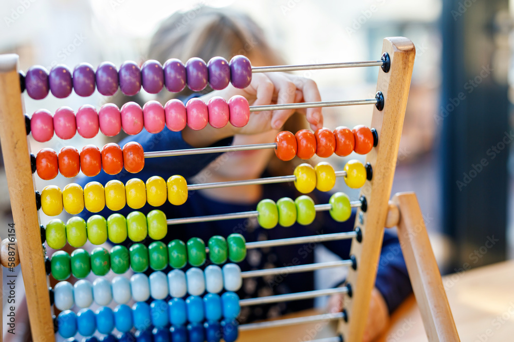 Little preschool girl playing with educational wooden rainbow toy ...