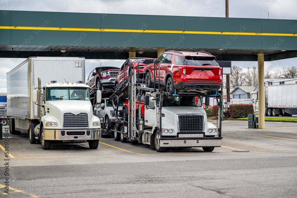 Photo Stock Powerful industrial big rig semi trucks with dry van and ...