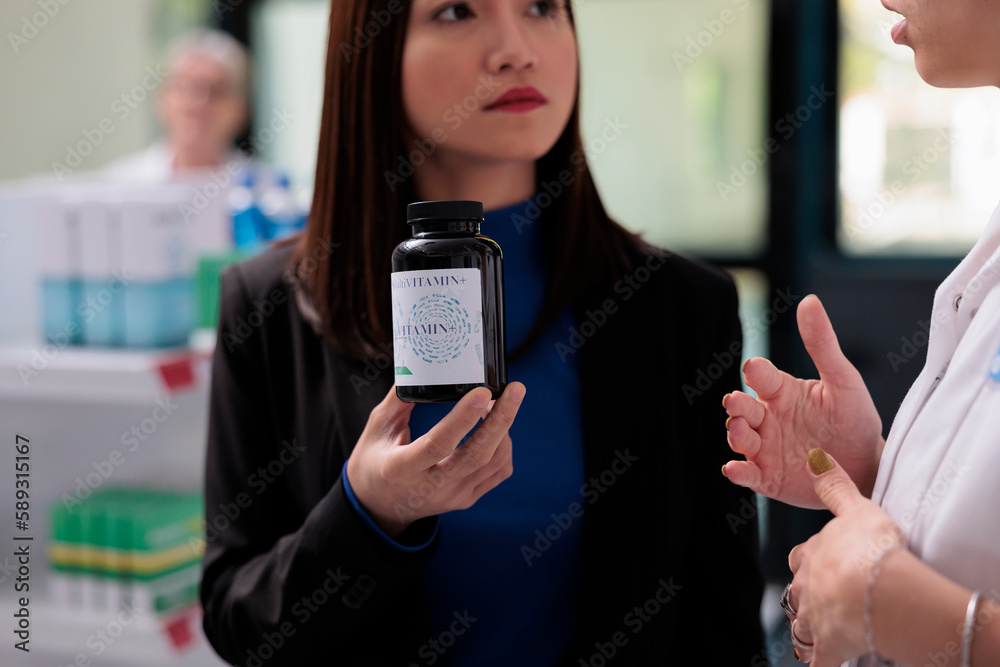 Pharmaceutical consultant explaining customer vitamin and mineral ...
