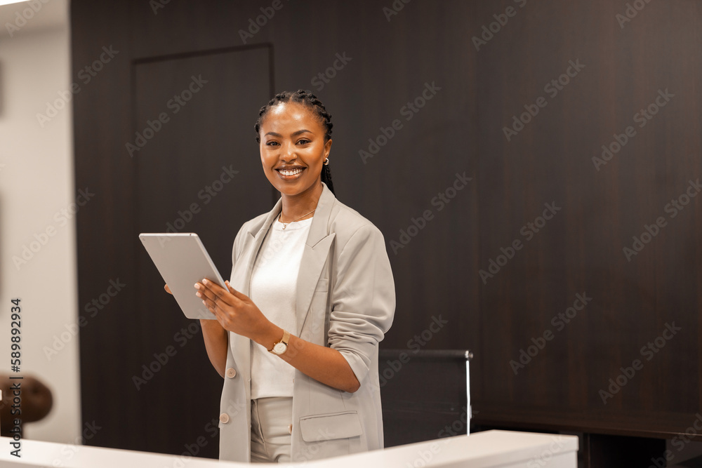 The young African-American female receptionist stands behind the ...