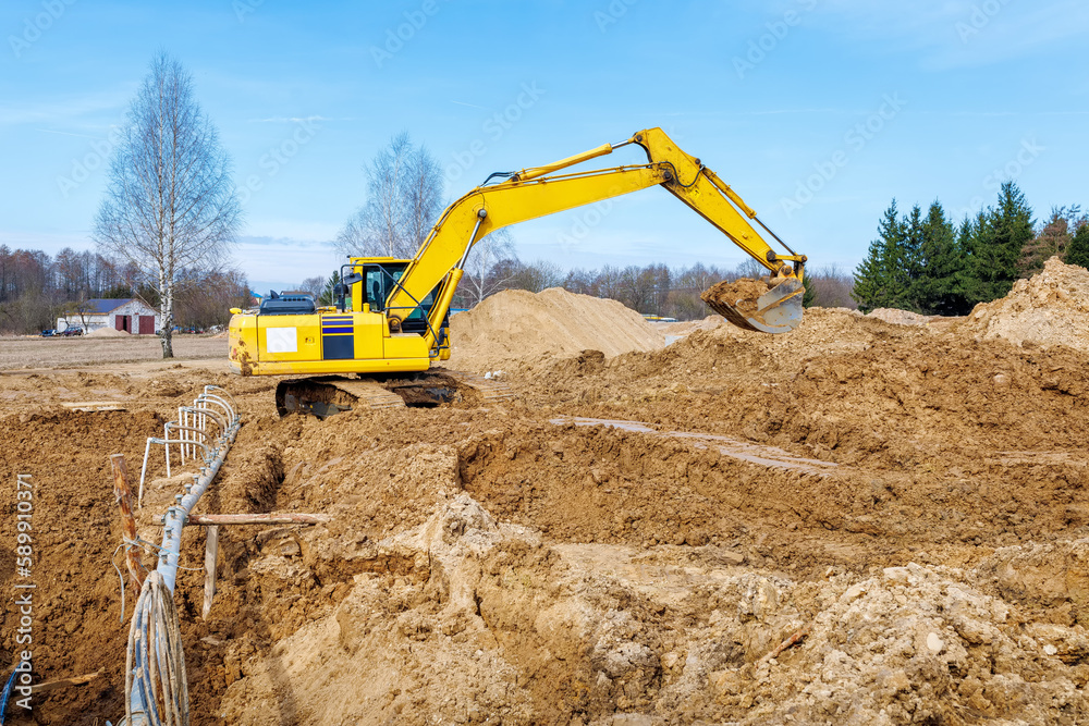 Excavator dig the trenches at a construction site. Trench for laying ...