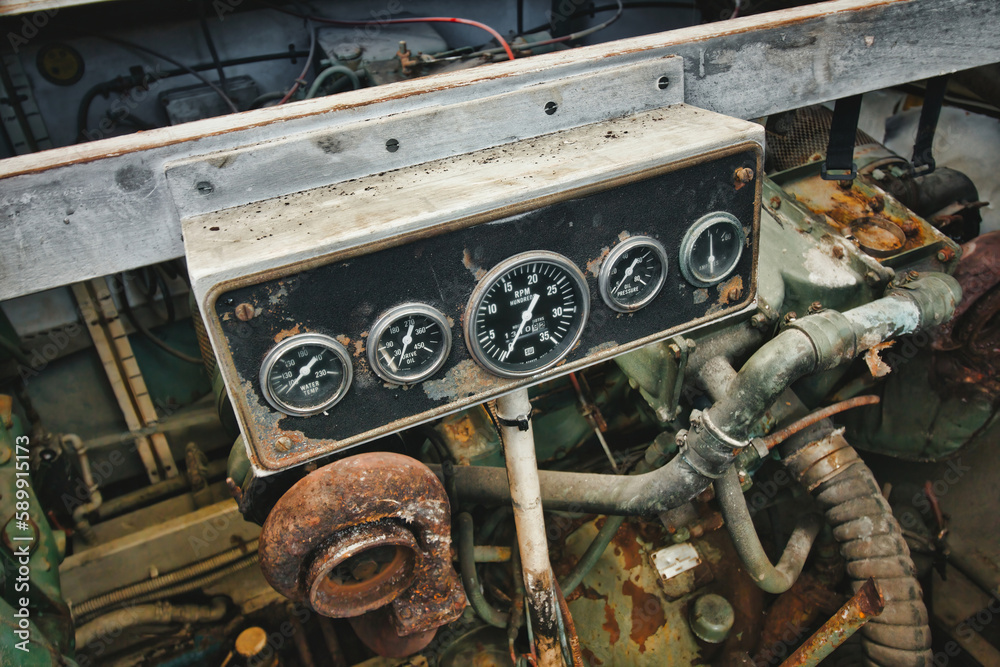 Dial gauge dashboard of a diesel engine in a engine room of a boat ...