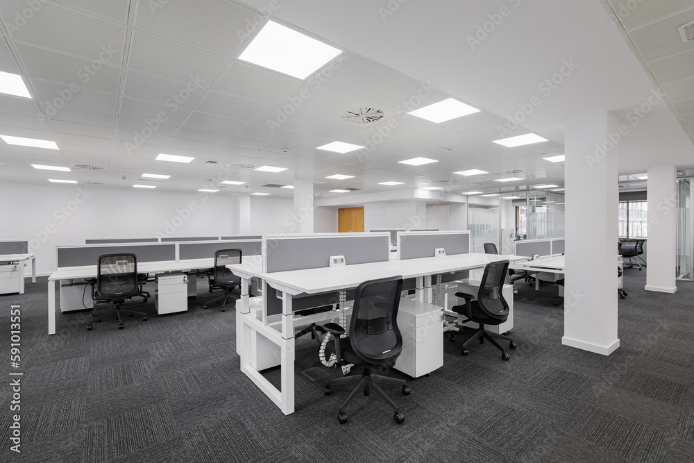 An empty gray call center office with tables and chairs after the ...