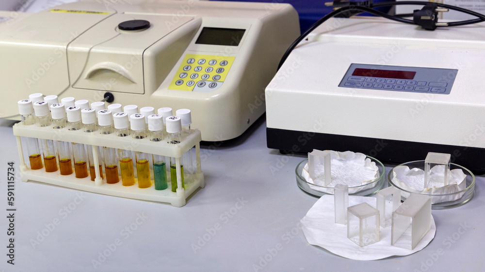 laboratory table with multi-colored reagent vials in the stand, clean ...