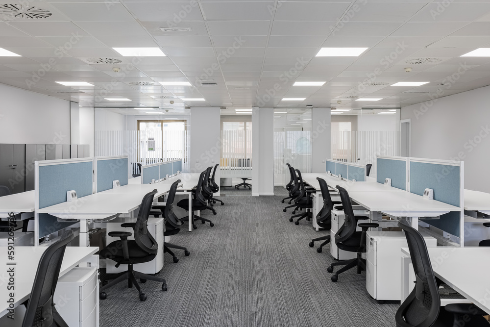 Spacious empty office in gray colors with comfortable office furniture ...
