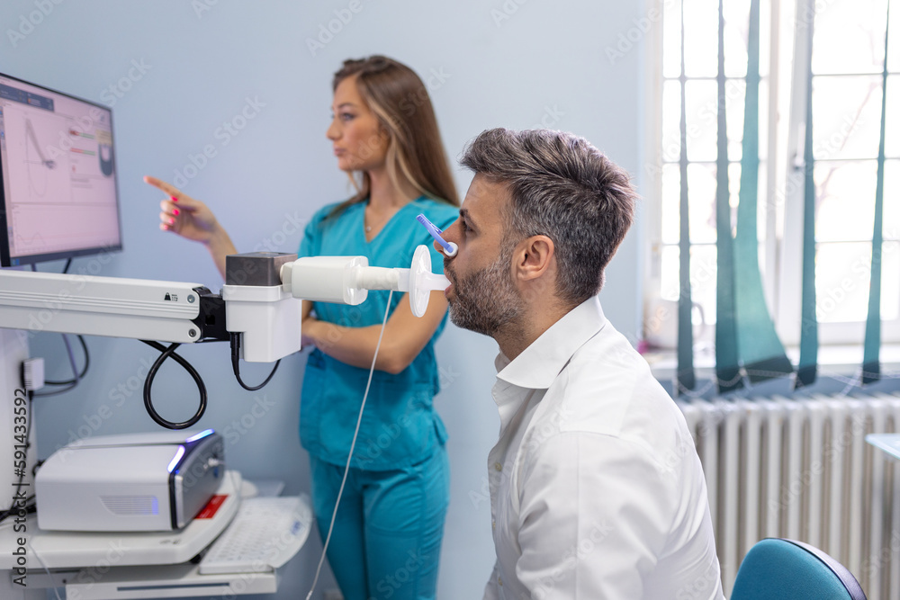 Man testing breathing function by spirometry. Diagnosis of respiratory ...