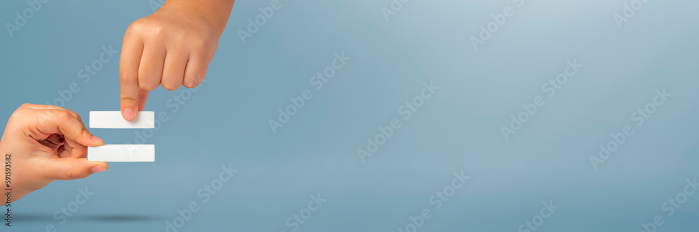 The symbol is equal in the hands of a child on a blue background. Two ...