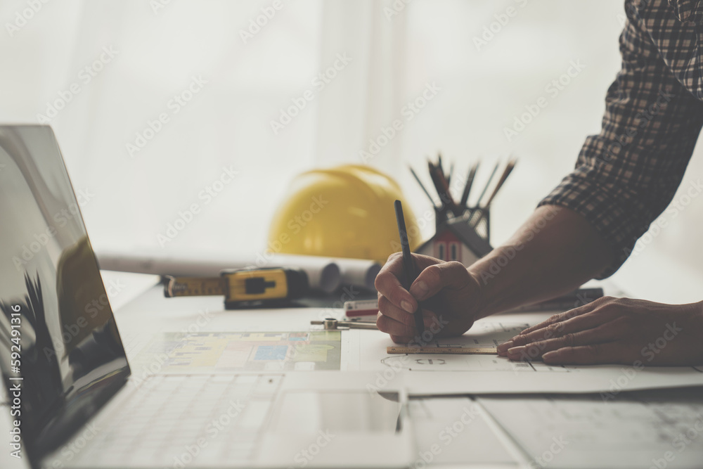 Engineer, architect, contractor starting to draw house plan structural blueprint on workbench ...