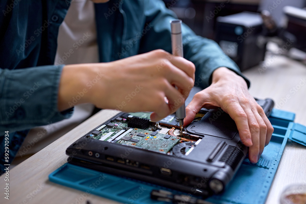 cropped professional IT specialist replacing details in computer repair ...