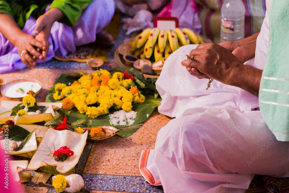 Hindu puja rituals being performed with flowers in front of priest ...