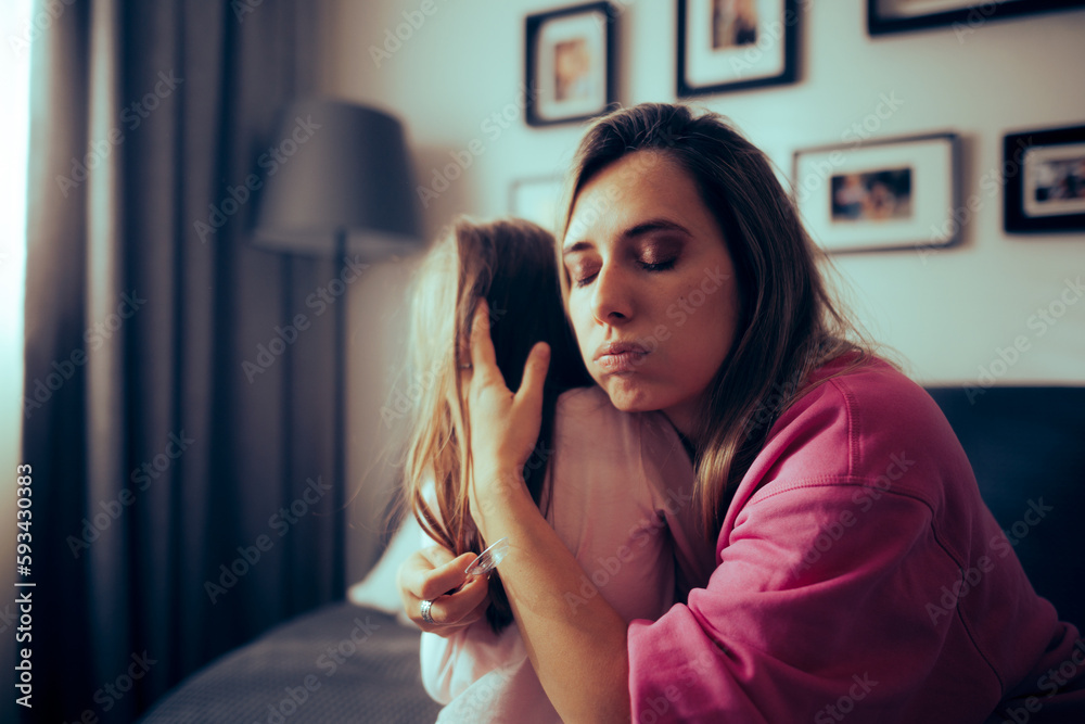 Worried Mom Embracing her Sick Child Giving her Comfort. Desperate mother holding her daughter ...