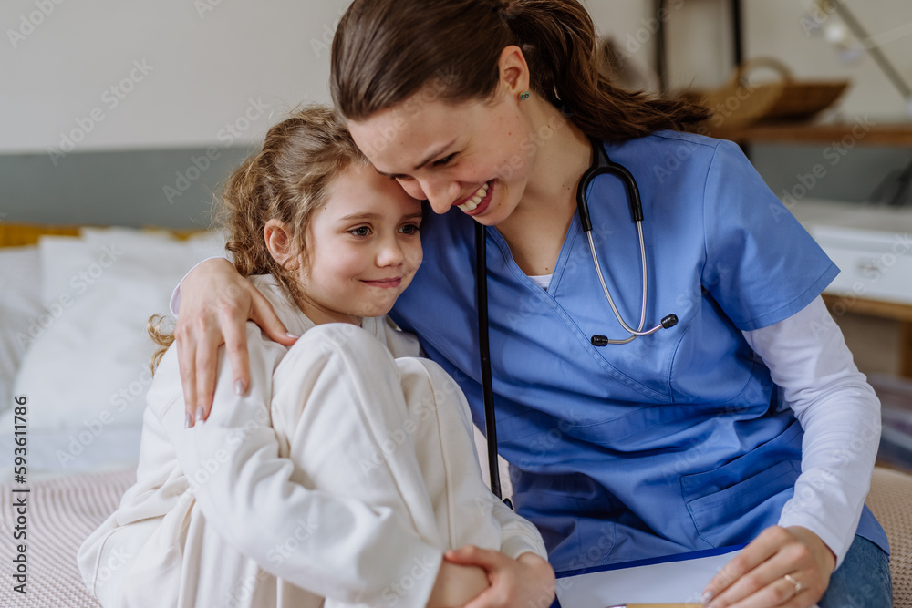 Young doctor hugging little girl in hospital room. Stock Photo | Adobe ...