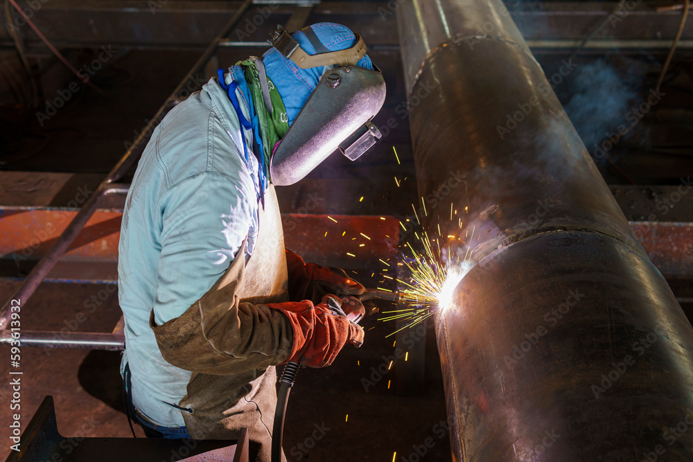 Welder is welding added joint a pipe carbon for steel structure work ...