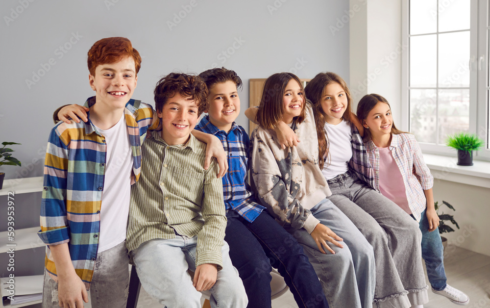 Group portrait of happy school friends. Several children sitting on a ...