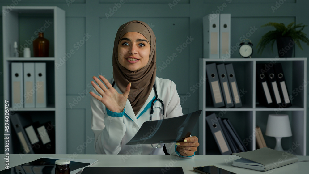 Positive doctor woman radiologist use video conference app talking with ...