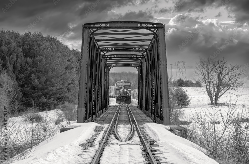 Train crossing a double span riveted railway truss bridge built in 1893 ...