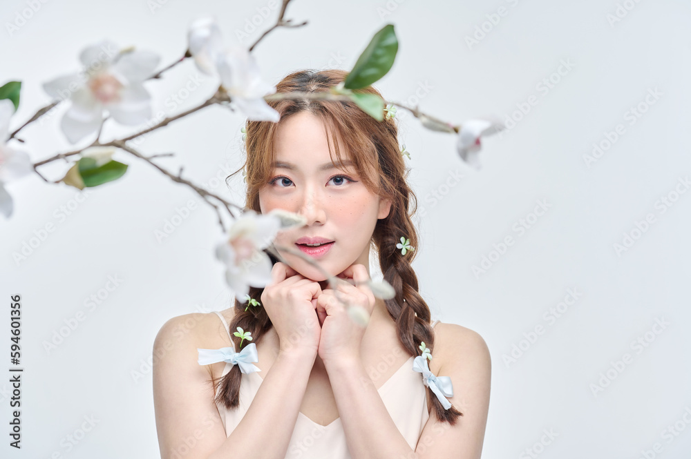 Beautiful Young Asian woman behind flower in beauty pose. Pretty girl ...