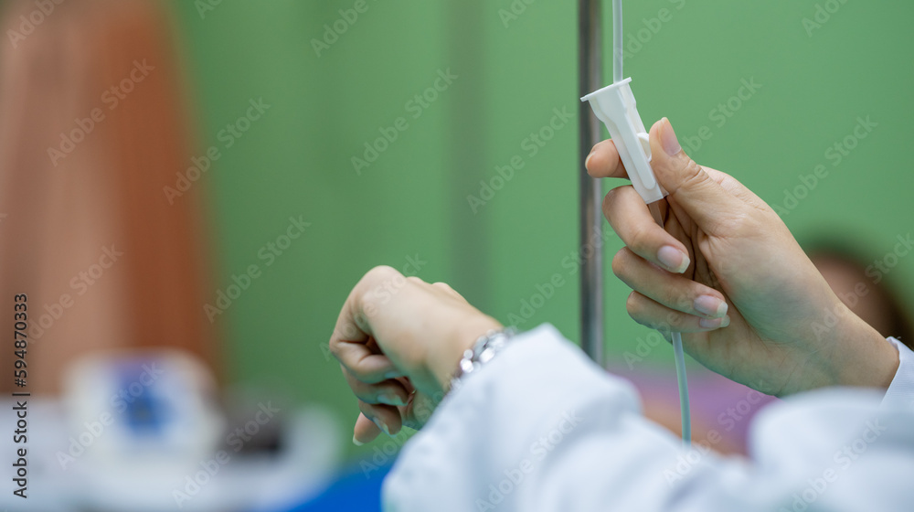 Woman doctor monitor Adjust the drip rate feed of saline dripping ...