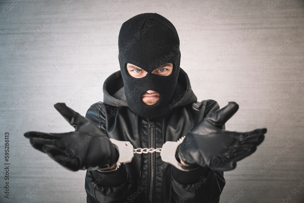 dangerous criminal is handcuffed in prison for interrogation. A ...