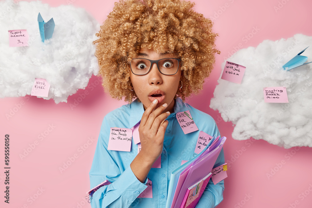 Shocked female office worker reacts to something surprising wears blue ...
