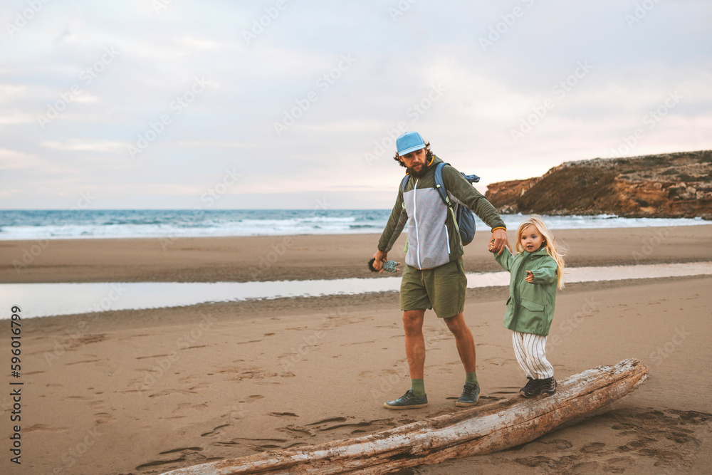 Family father walking with child on the beach summer vacations ...