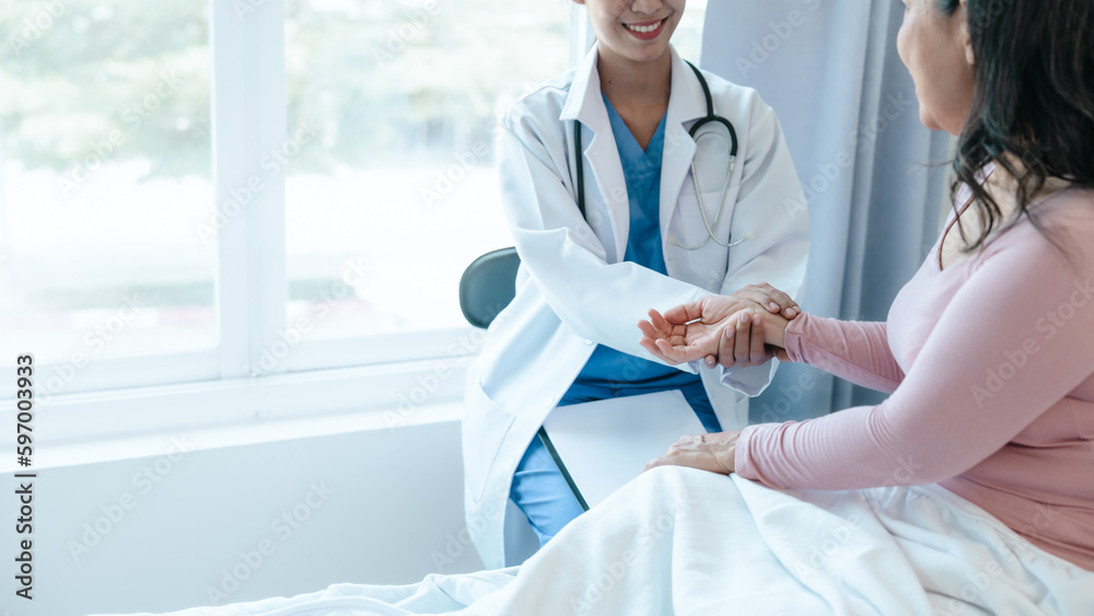 Asian Chinese female physiotherapist caregiver helping elderly woman ...
