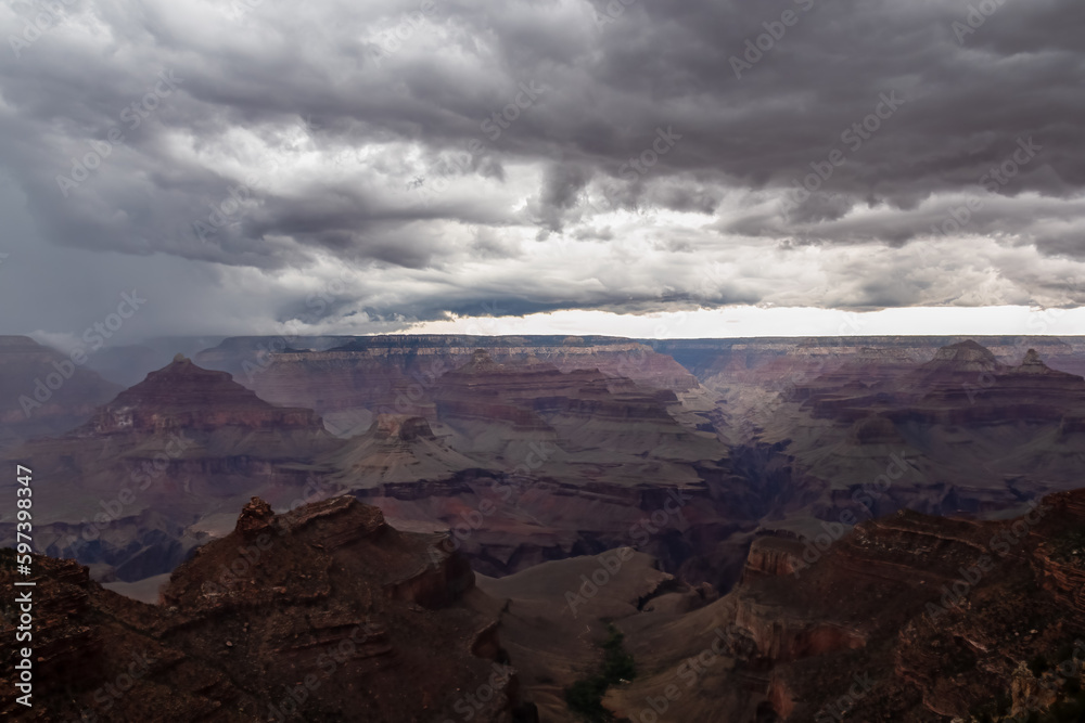 Dark clouds emerging to rain storm seen from the Bright Angel Point at South Rim of Grand Canyon ...