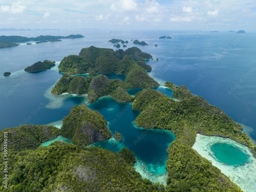 Beautiful coral reefs surround the dramatic limestone islands that rise ...