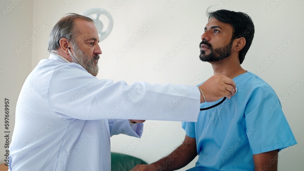 Asian senior male doctor holding examining heart by stethoscope of ...