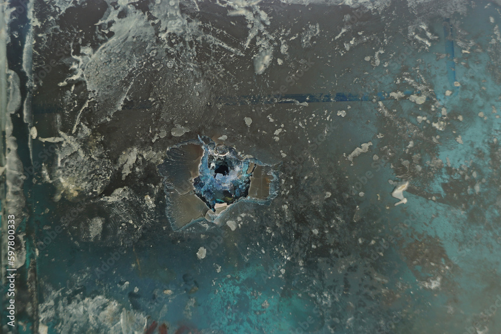 Damaged holes on X-ray film from being shot by a 9mm pistol bullet ...