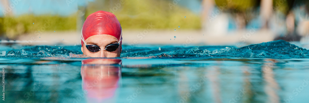 Swimming athlete man creative portrait wearing swim goggles and swim ...