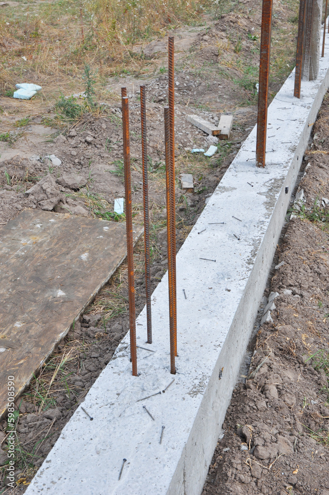 The concrete footer for new fence mounting. Fence footings. Close up on ...