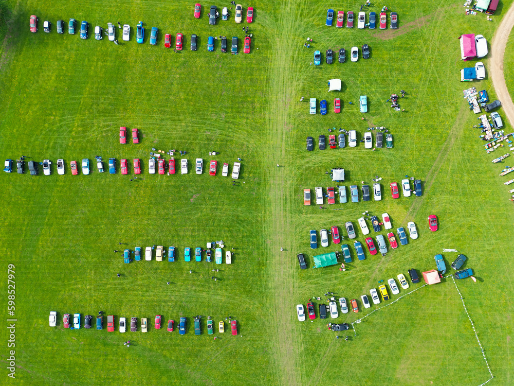 Fotografie Drone top down views of distant parked classic cars seen on ...