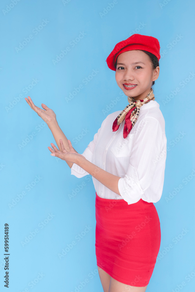 A flight attendant or stewardess guiding people to the right side. A ...
