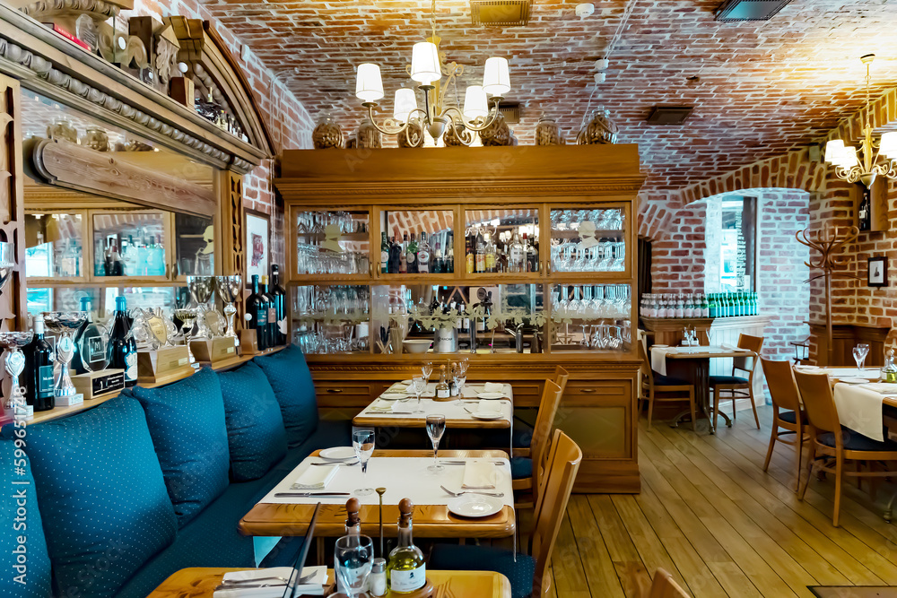 LATVIA, RIGA, MAY, 2023: Cozy restaurant interior with restored ...