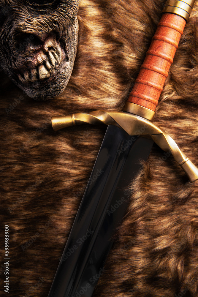 Sword placed diagonally over a black fur cover and a decaying head in ...