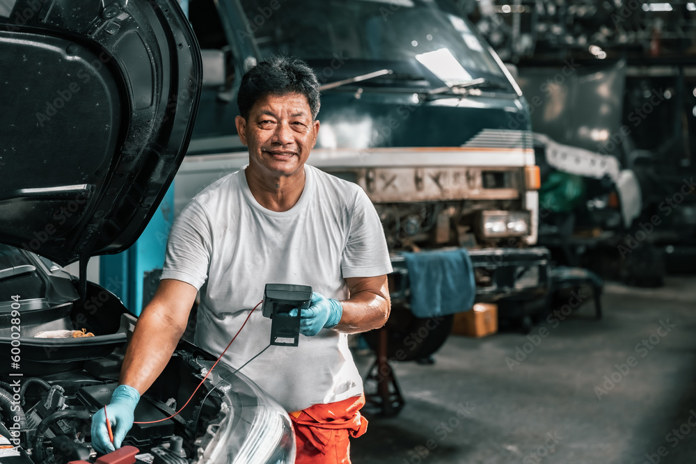 Experienced auto mechanics inspect car battery terminals and voltage to ... Experienced auto mechanics inspect car battery terminals and voltage to ...