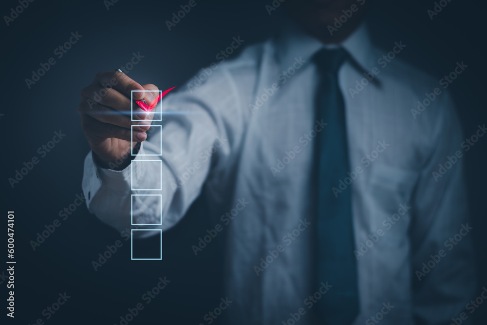 businessman holding a pen check mark red In the checkbox, checklist concept document ...