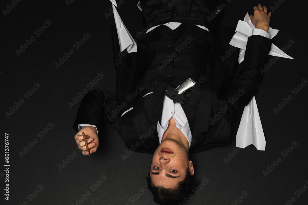 Lying on a floor Young mafia member with a slicked back hair, dressed ...