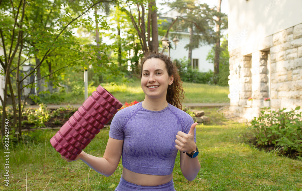 Woman presenting massage roll. Massage roll in the hands of a girl. The ...